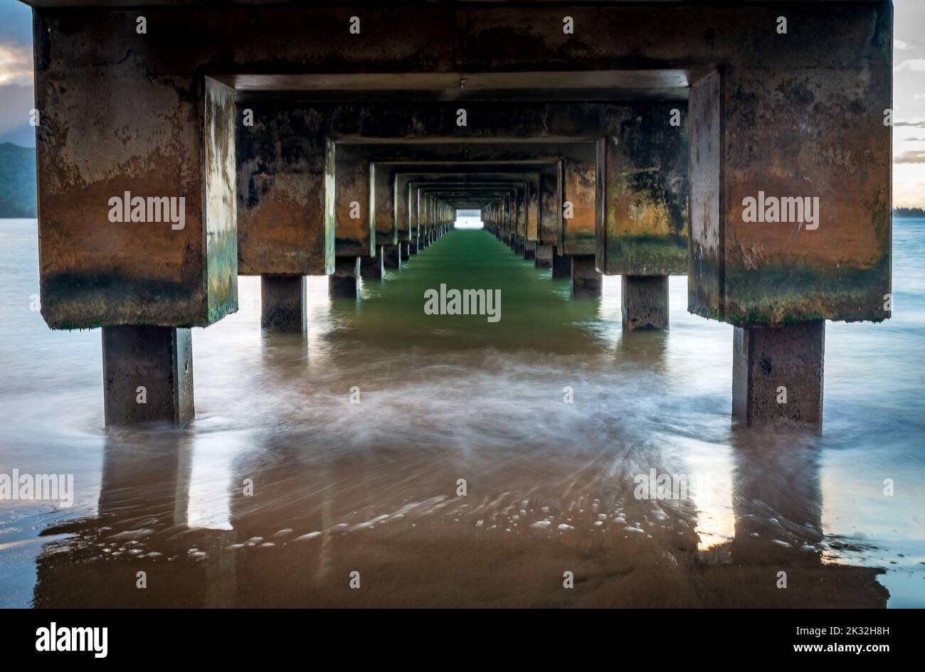 An undershot of a stone huge building on the Hanalei Bay with waves ...