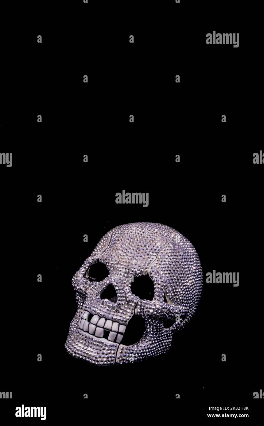 A diamond skull with broken teeth on a black background Stock Photo - Alamy