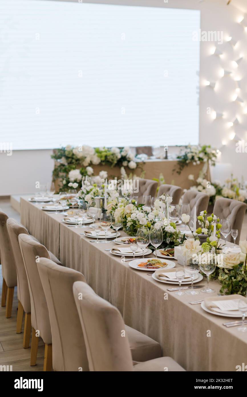 Tables setting at a luxury wedding. Table for guests. Dishes and drinks ...