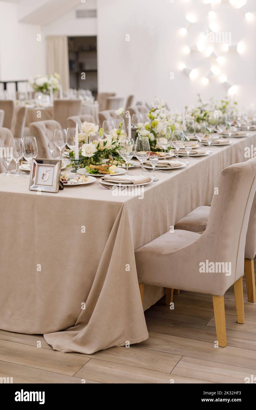 Tables setting at a luxury wedding. Table for guests. Dishes and drinks ...
