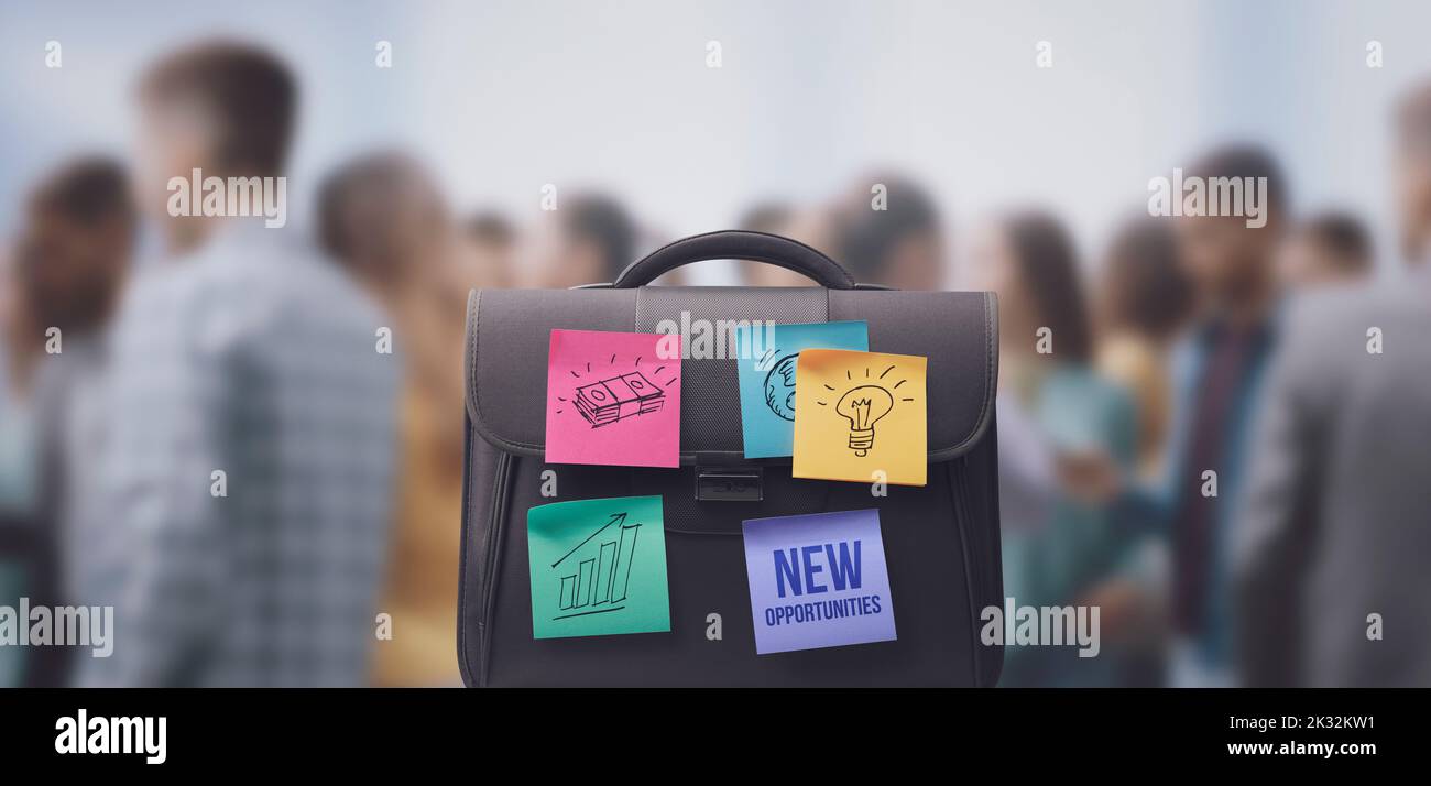 Sticky notes with business icons and group of people in the background ...