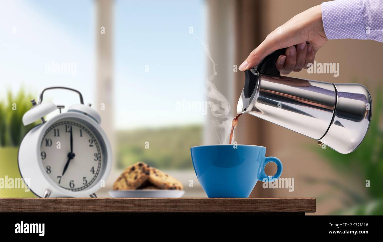 Woman having a coffee break, she is pouring hot coffee in a cup Stock ...
