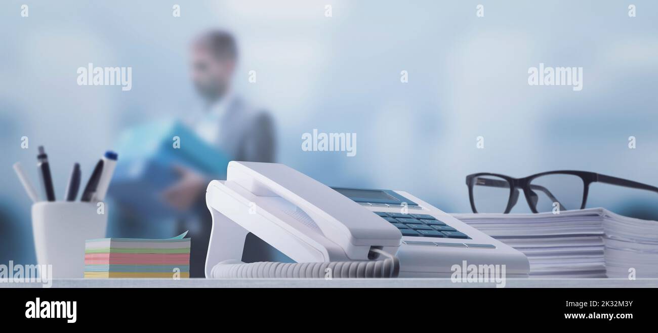 Corporate business desktop in the office with telephone and paperwork ...