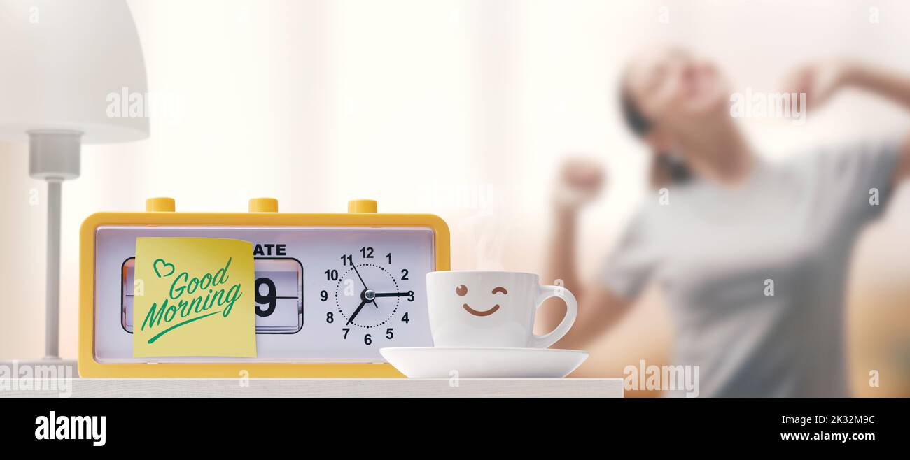 Alarm clock with good morning message and smiling coffee cup, a woman ...