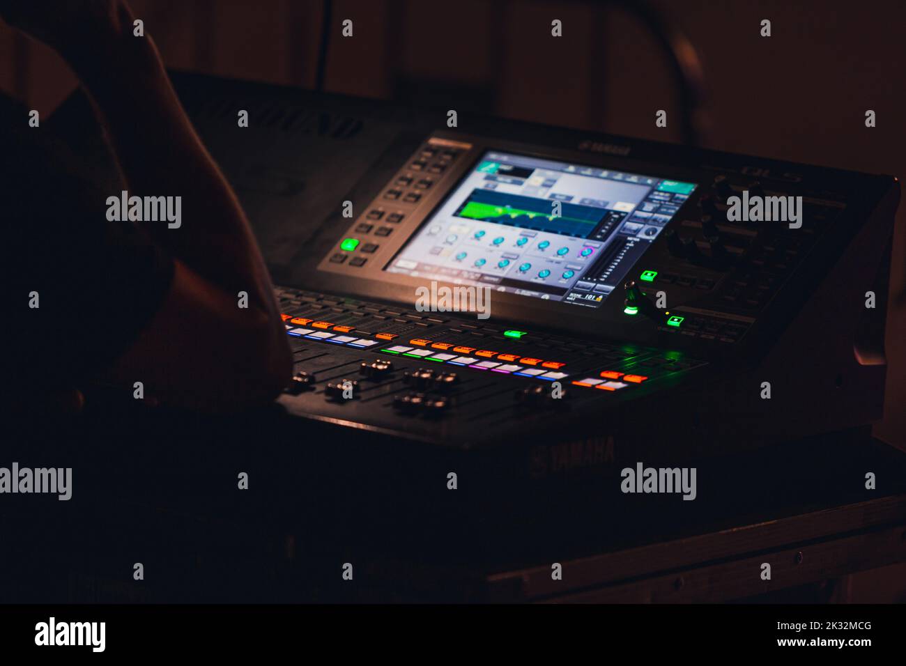 An audio mixing table a minute before soundcheck with the band on stage ...