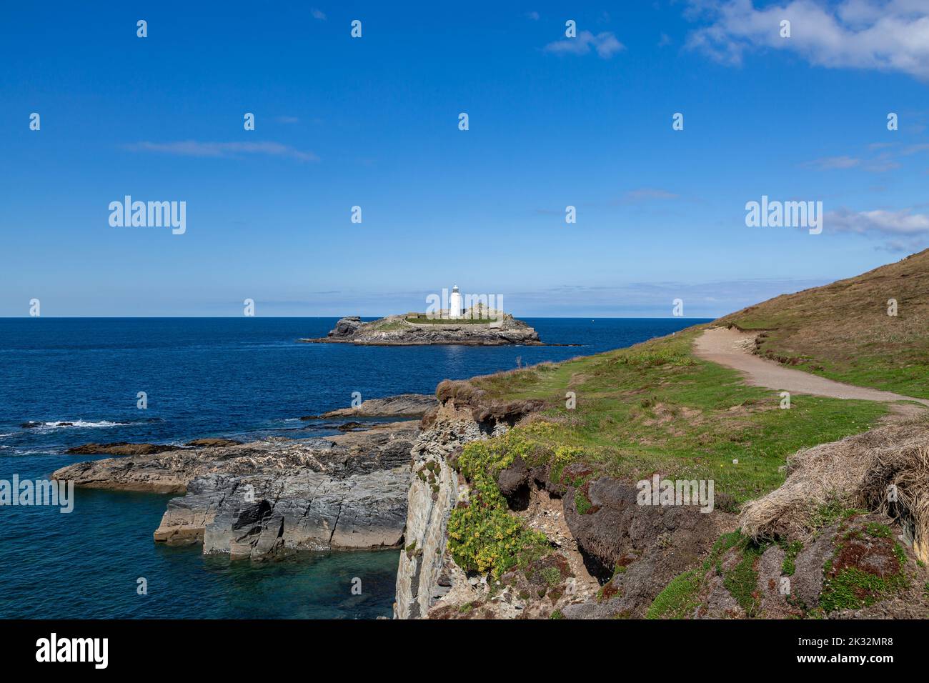 A view along the coastal path towards Godrevy island and lighthouse in ...