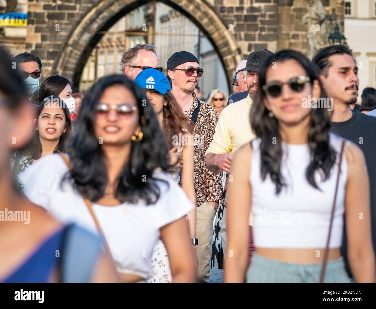 Prague, Czech Republic - June 2022: Crowds of tourist people walking and strolling on the famous ...