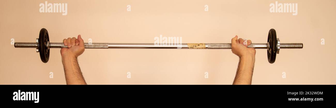 A person arm hold lift barbell motivation effort isolated on cream ...