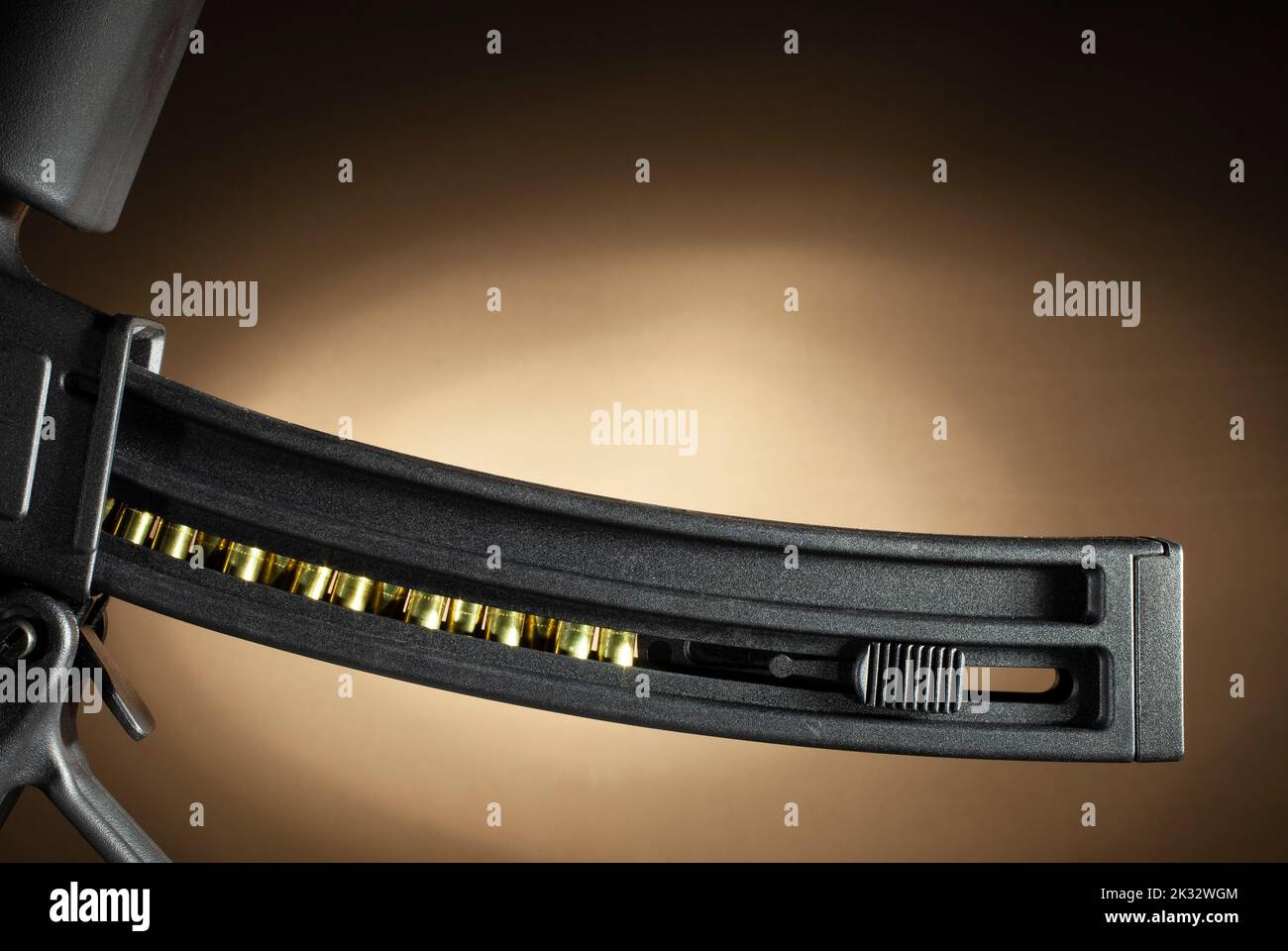 Cartridges in a rimfire rifle magazine with a brown background Stock ...