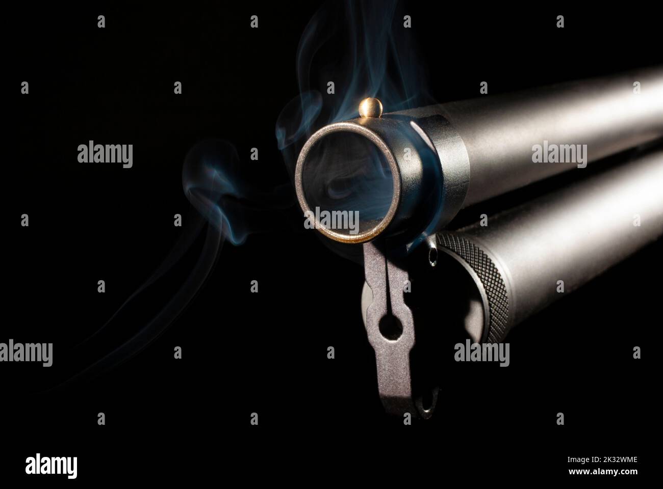 Shotgun with smoke around its barrel on a black background Stock Photo ...