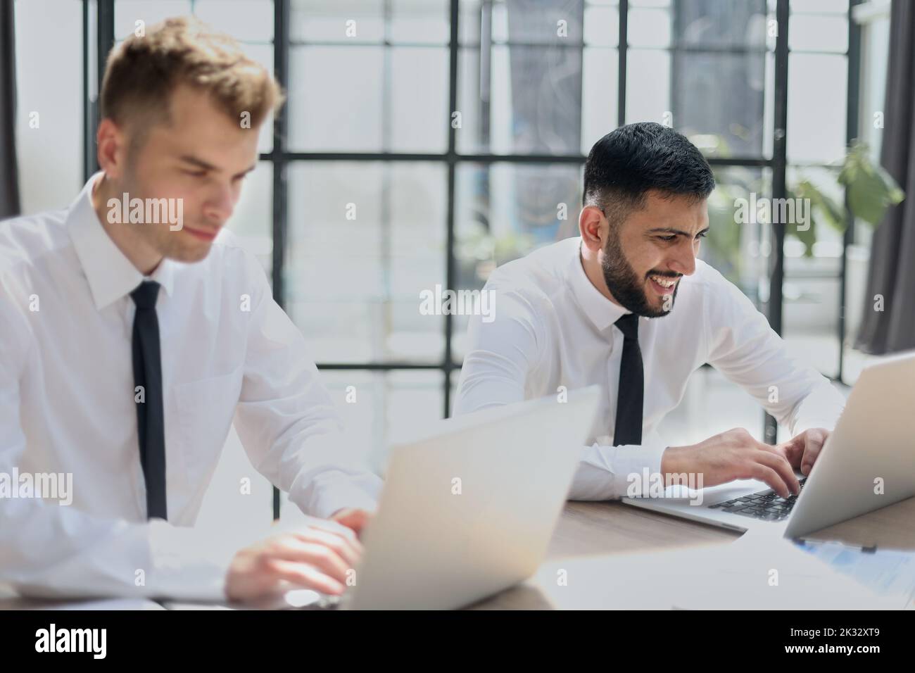 Two happy men working together on a new business project Stock Photo ...