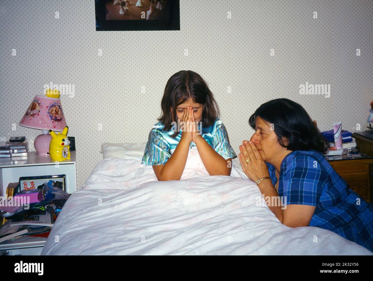 Mother and Daughter Praying together at Bedtime Surrey England Stock ...