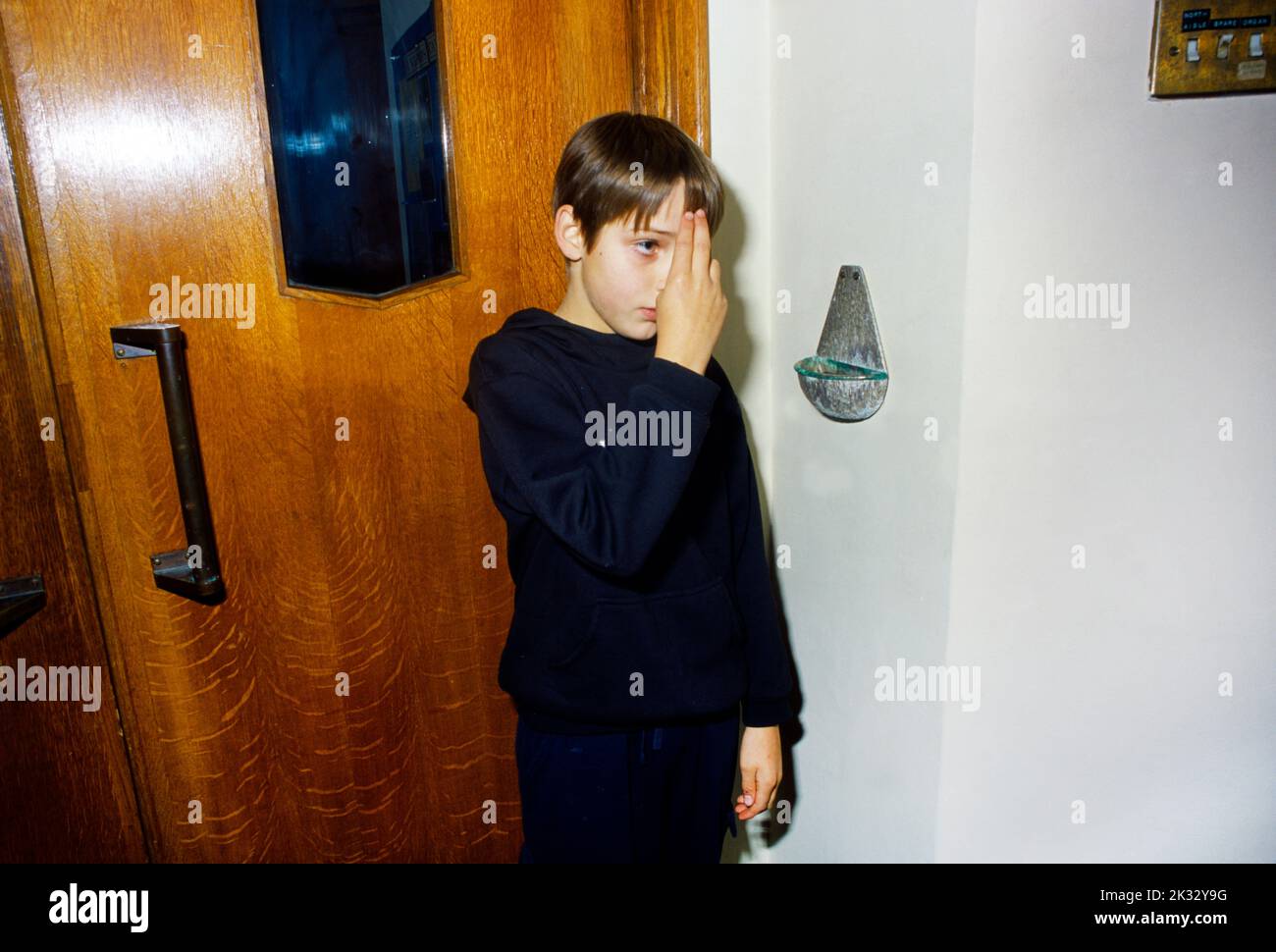 St Bernard's Catholic Church Lingfield Surrey England Boy Dips Fingers ...