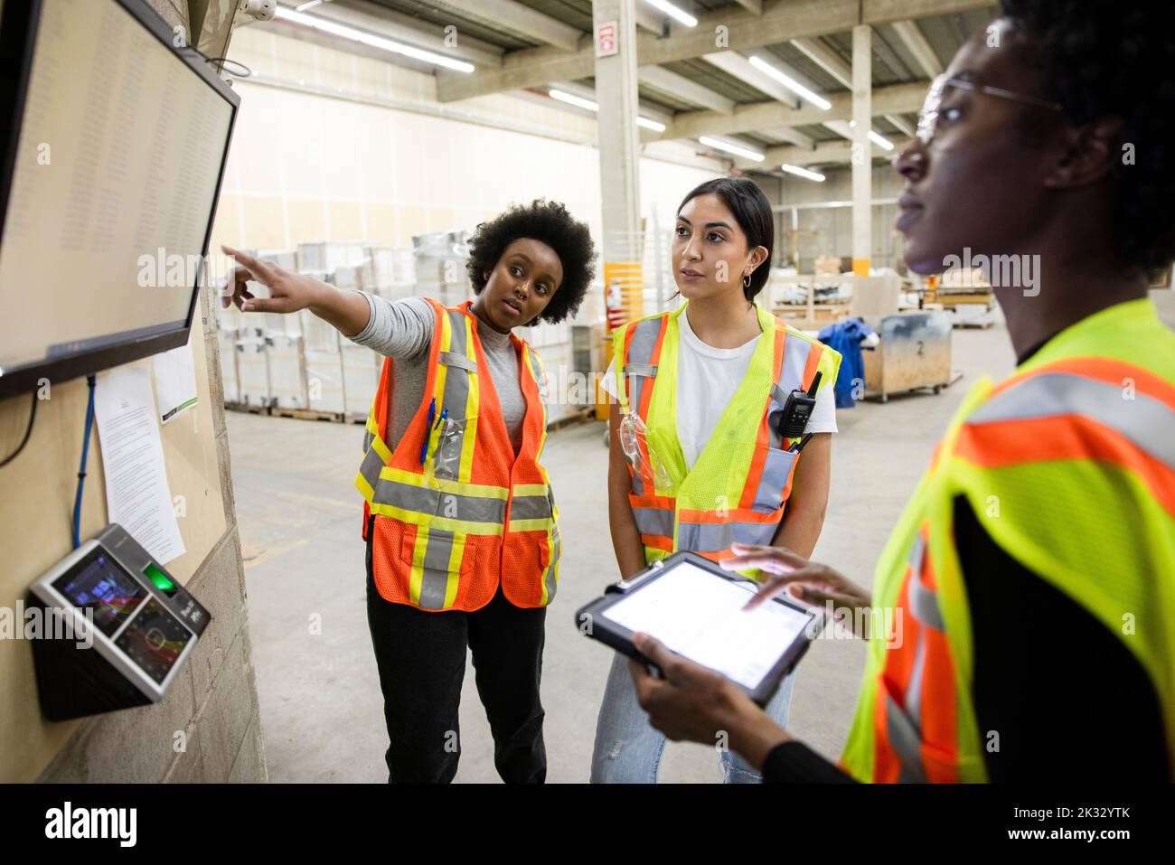 Colleagues working with digital devices in distribution warehouse Stock ...