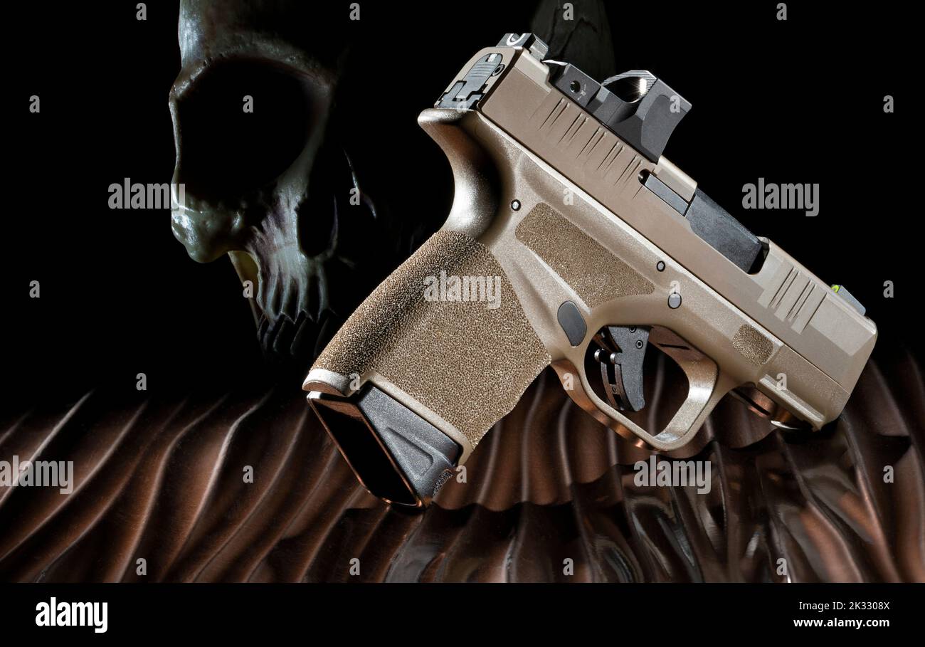 Ghost gun that is a semi automatic pistol with skull behind Stock Photo ...