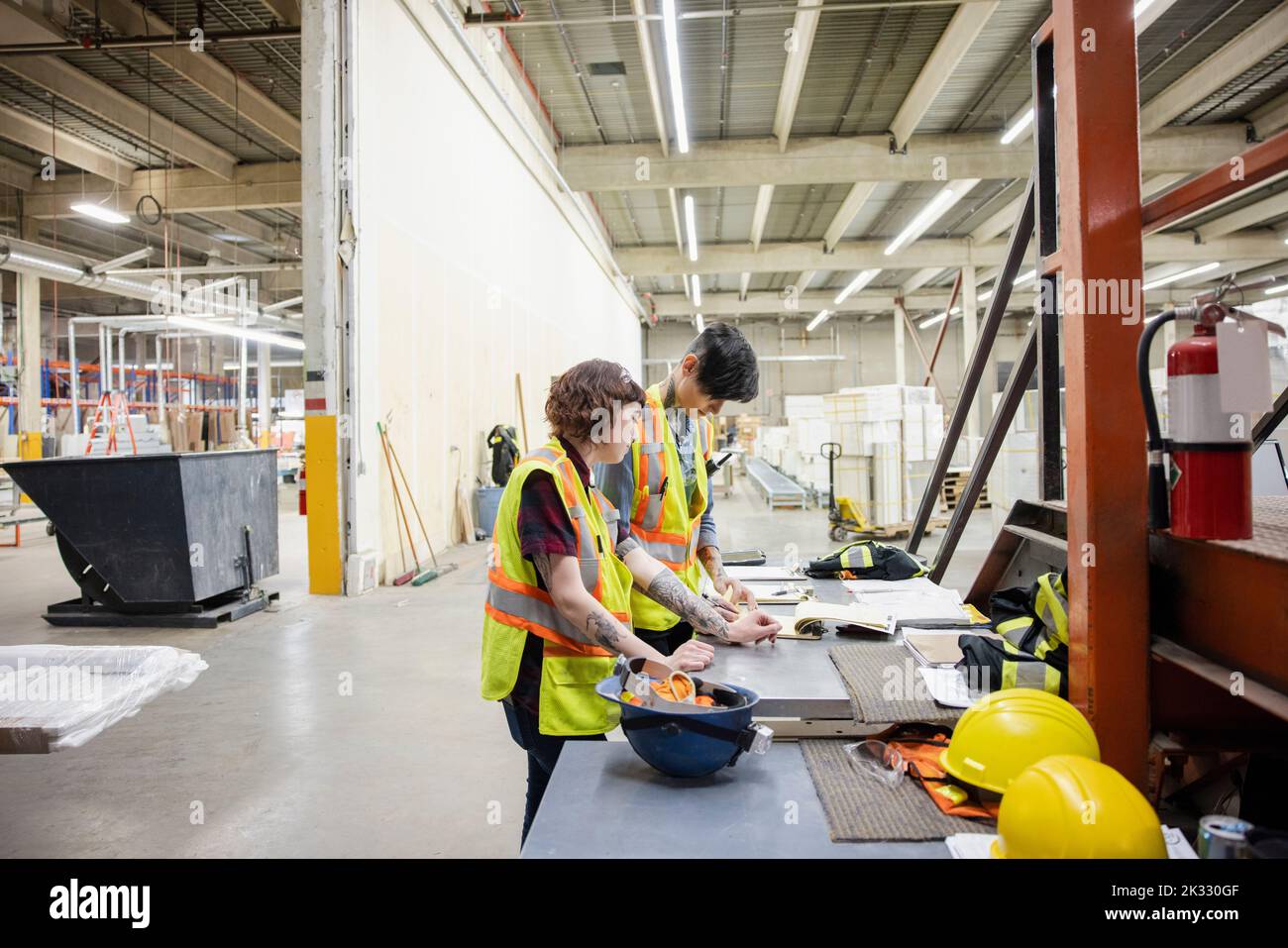 Colleagues discussing work in distribution warehouse Stock Photo - Alamy