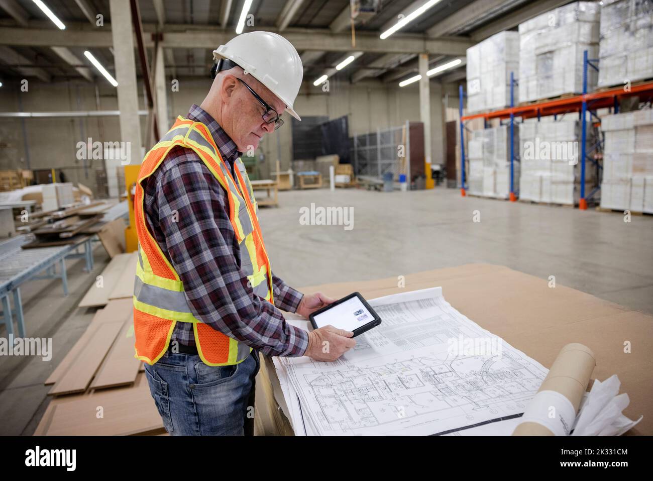 Architect working with digital tablet in distribution warehouse Stock ...
