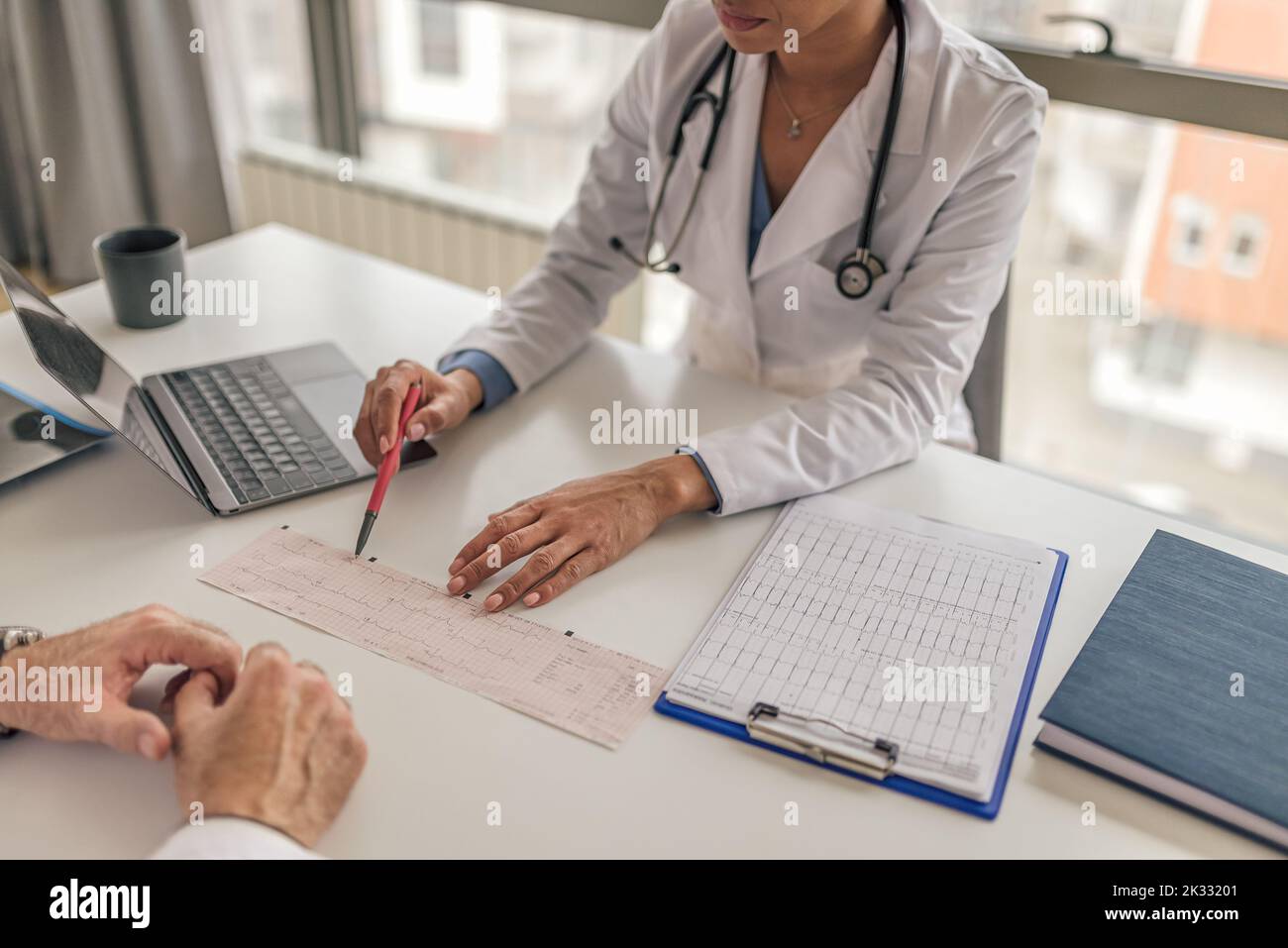 Picture of female african-american doctor, showing the patients heart ...