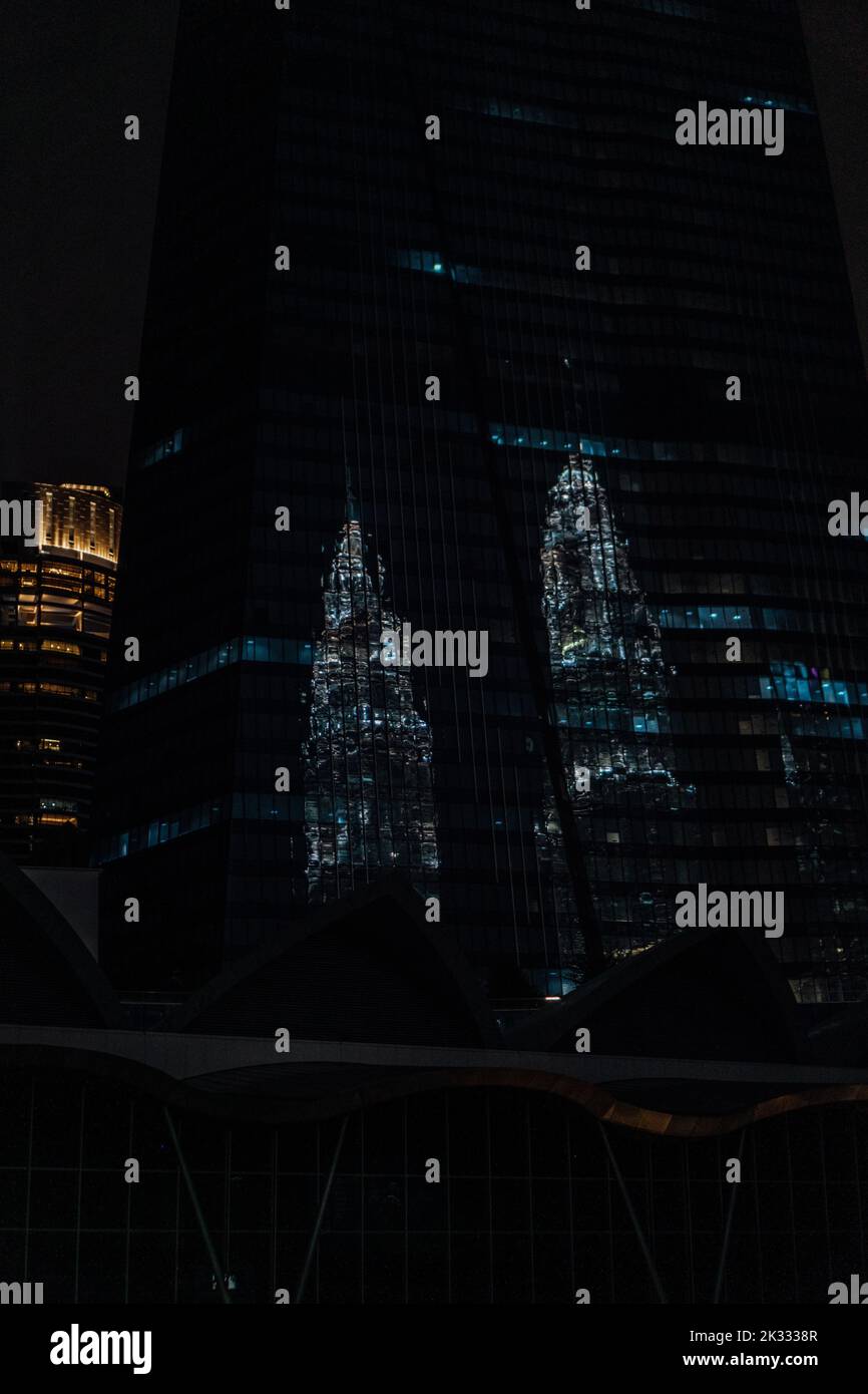The modern illuminated towers reflecting on a building at night Stock ...