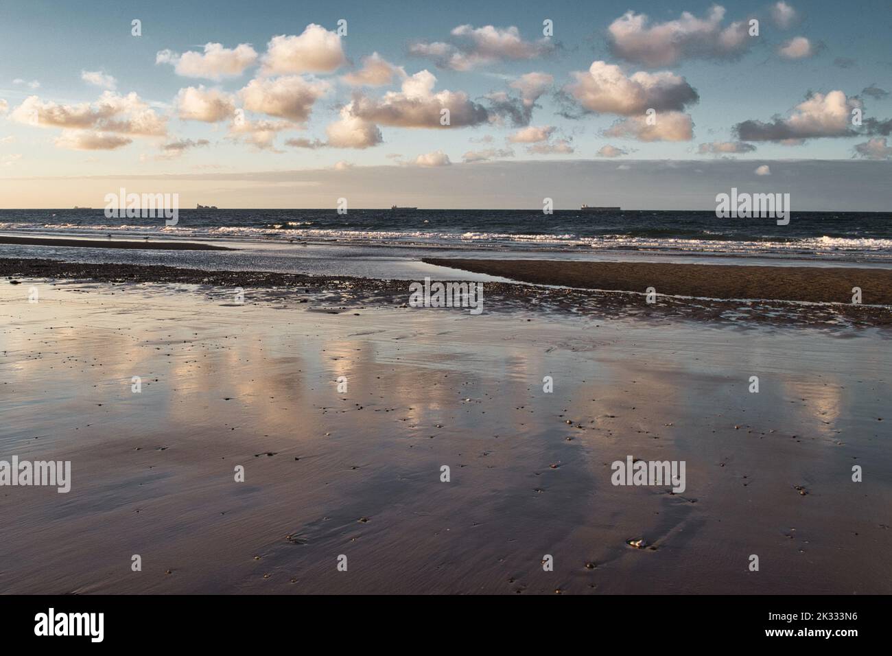 A beautiful shot of a sunset sky over the sandy beach Stock Photo - Alamy
