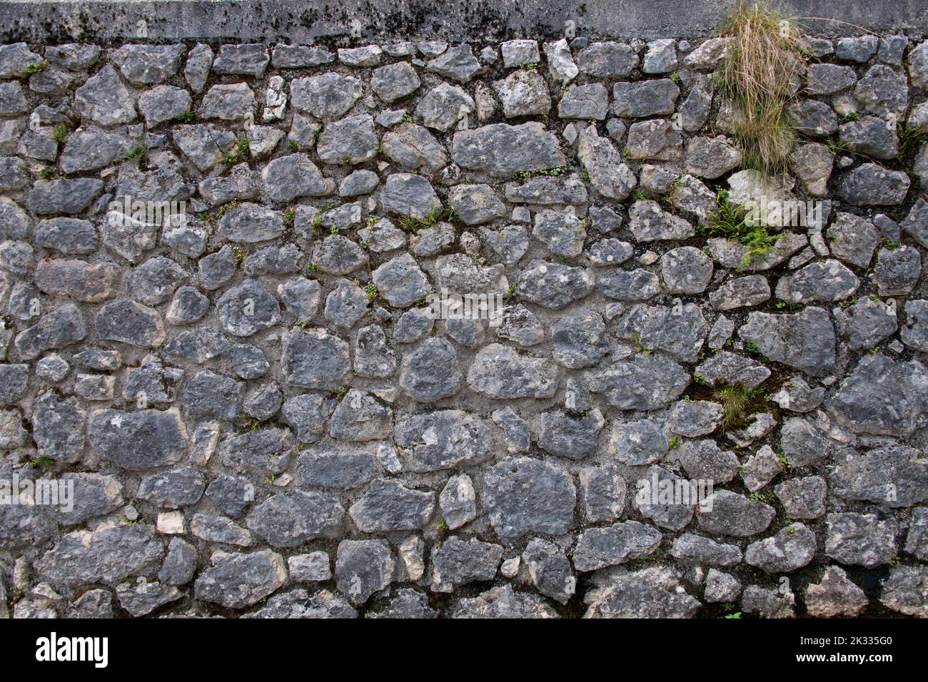 partial close up view of an old stone wall made of rounded simple ...