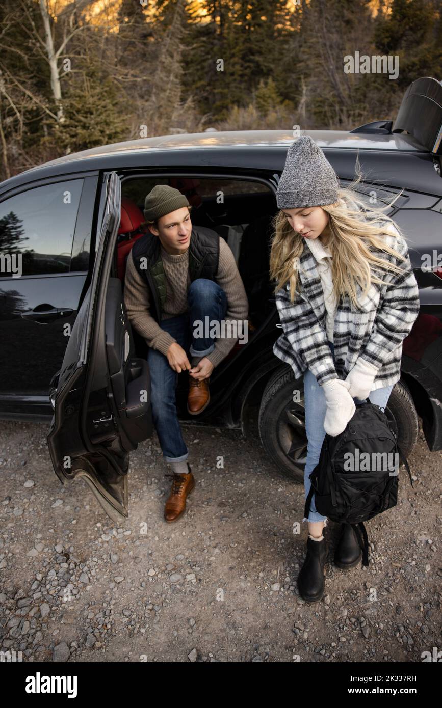 Couple getting ready to go hiking in mountains Stock Photo - Alamy