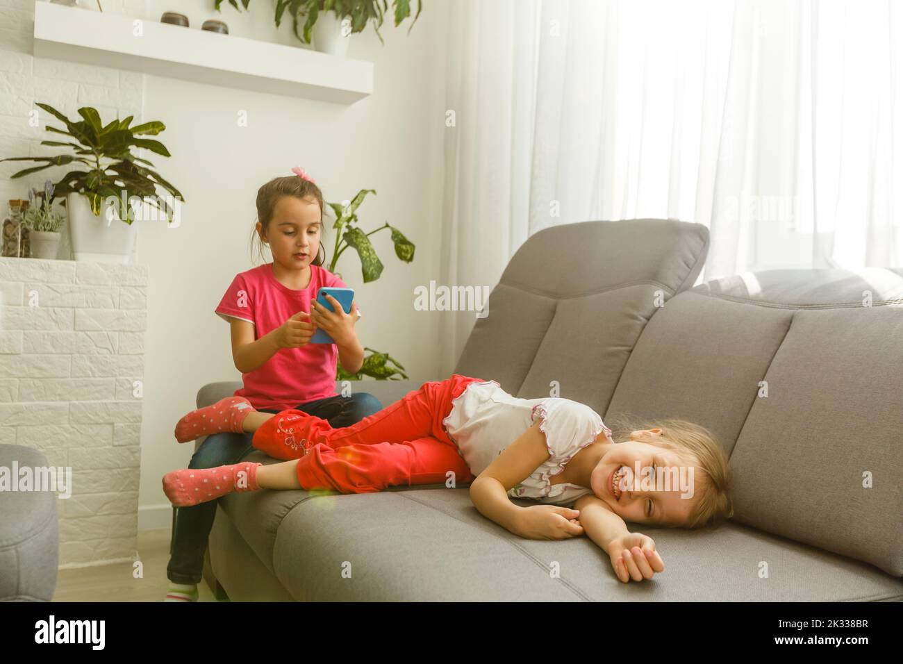 Two little girls are playing at home. Childhood Stock Photo - Alamy