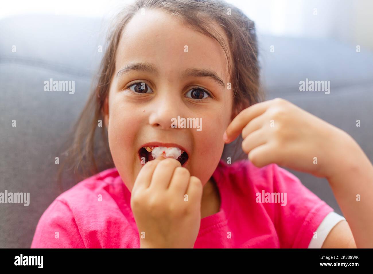 closeup portrait of funny smiling little girl without one front tooth ...