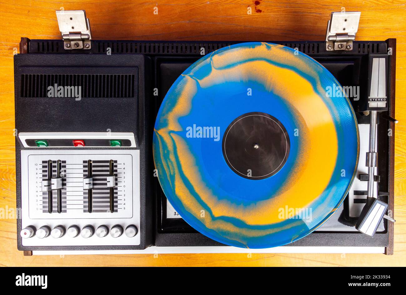 Vintage turntable vinyl record player with blue and orange vinyl on a ...