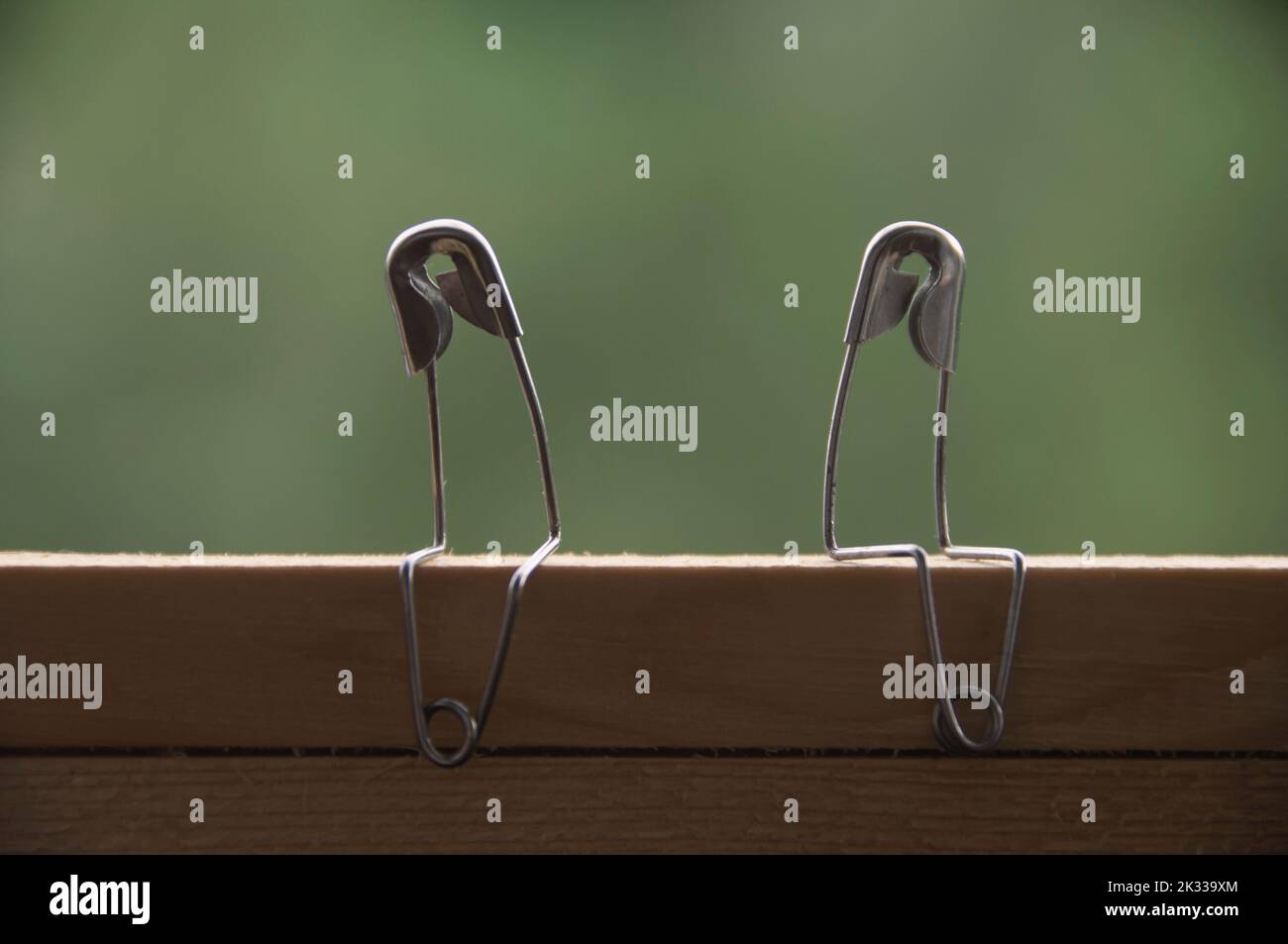 Safety Pin Couple Sitting On Table With Customizable Space For Text And