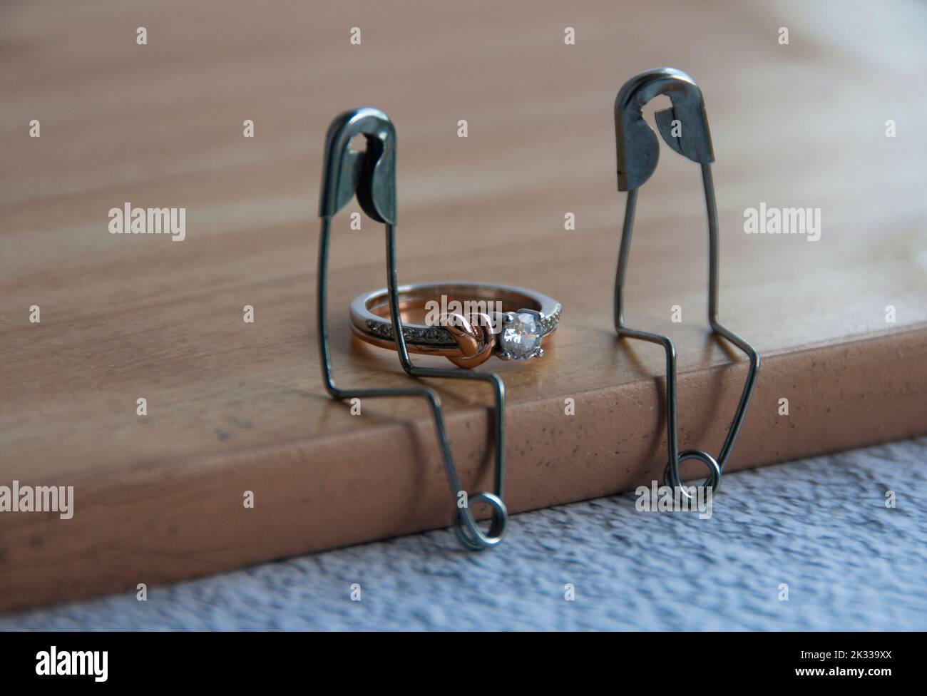 Safety pin couple sitting on table with golden right and customizable ...