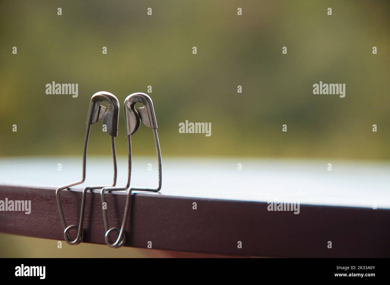 Safety Pin Couple Sitting On Table With Customizable Space For Text And