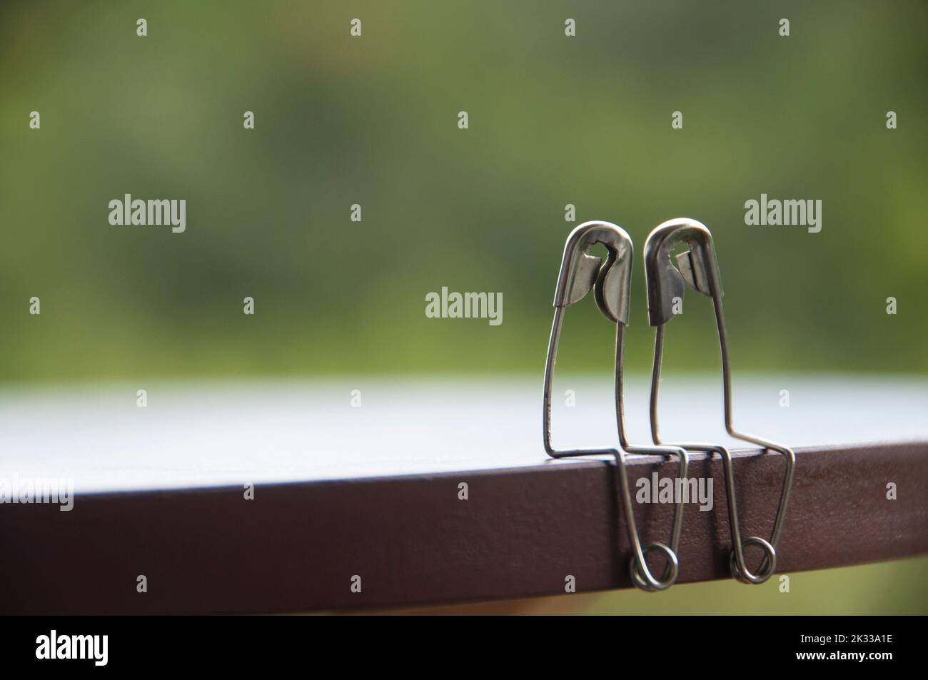 Safety pin couple sitting on table with customizable space for text and ...