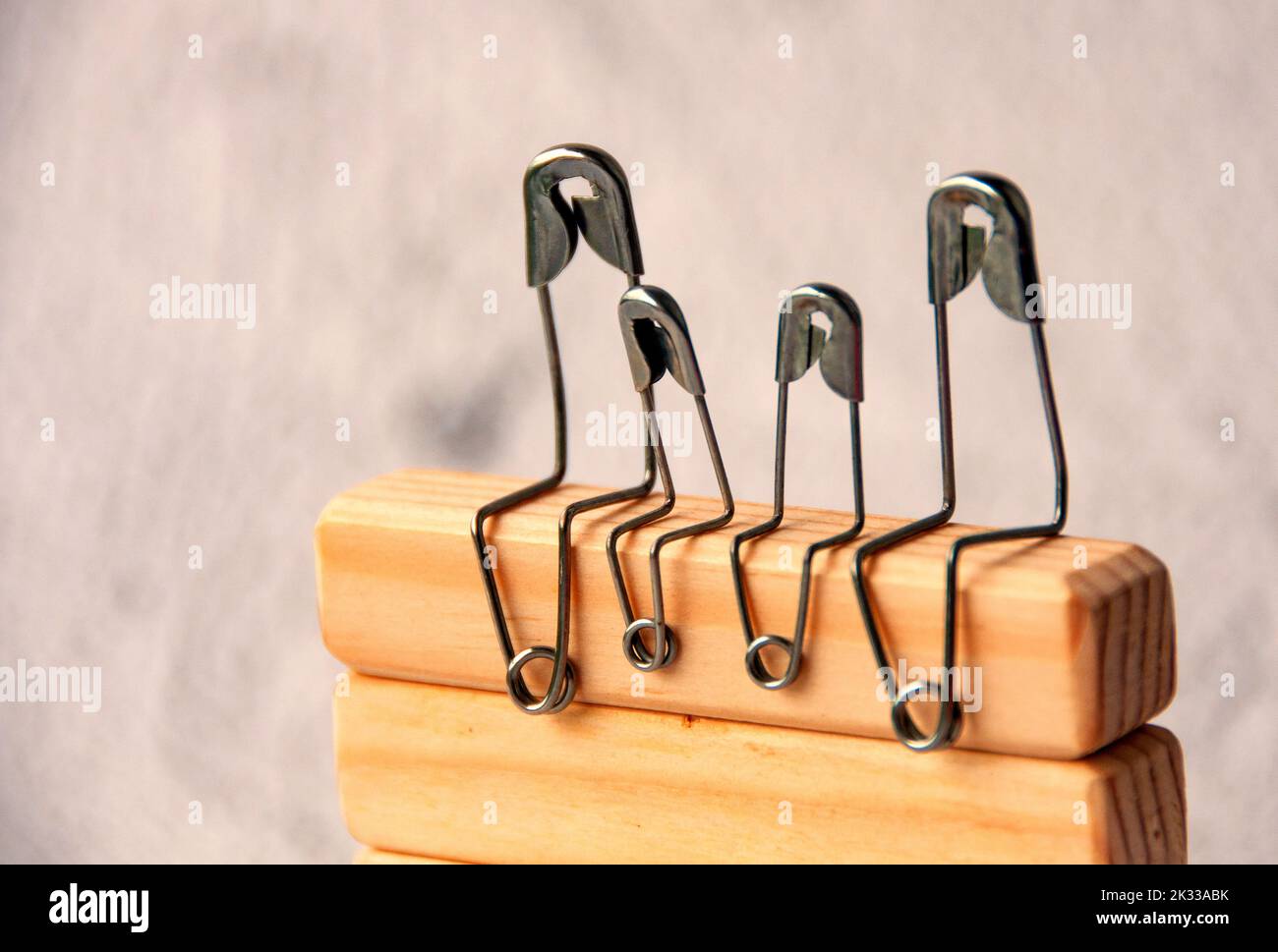 Model safety pin of family sitting on wooden blocks. Family concept ...