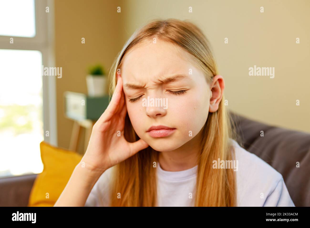 Cute child girl wearing casual clothes with hand on head for pain in ...