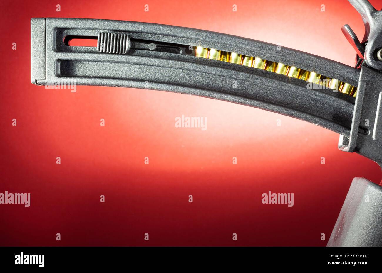 Rimfire rifle magazine loaded with ammo with copy space below on a red ...