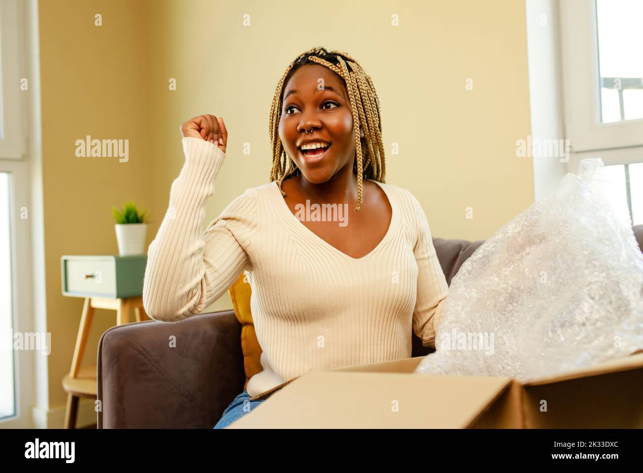 african american woman packing things in a box for moving Stock Photo ...