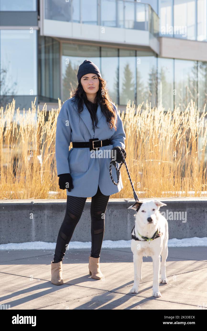 Beautiful woman walking in the park with her dog hi-res stock ...