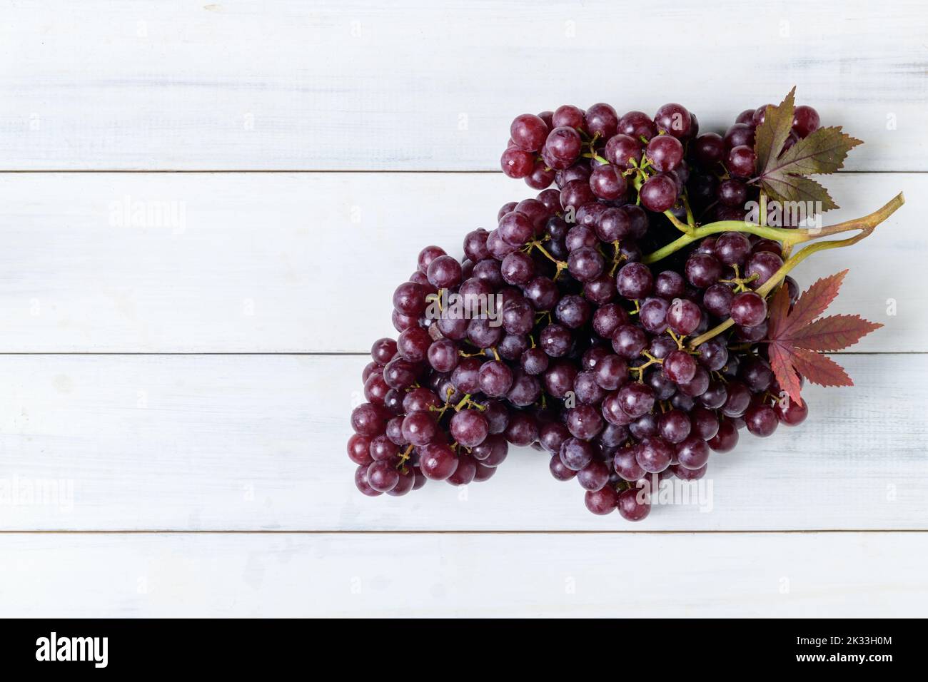 Champagne grapes on white wood background.Champagne grapes are very ...
