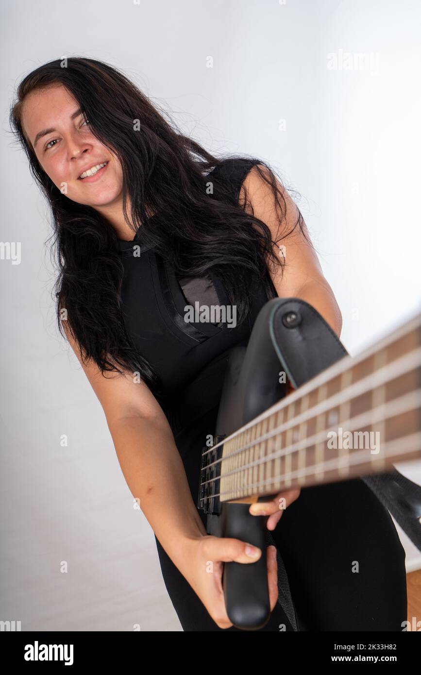 Posing girl with bass guitar on white background Stock Photo - Alamy