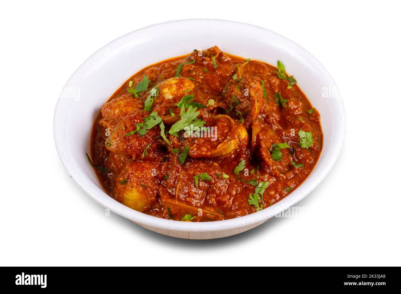 Shell Fish Masala Fry Served in a bowl over white background. Selective ...