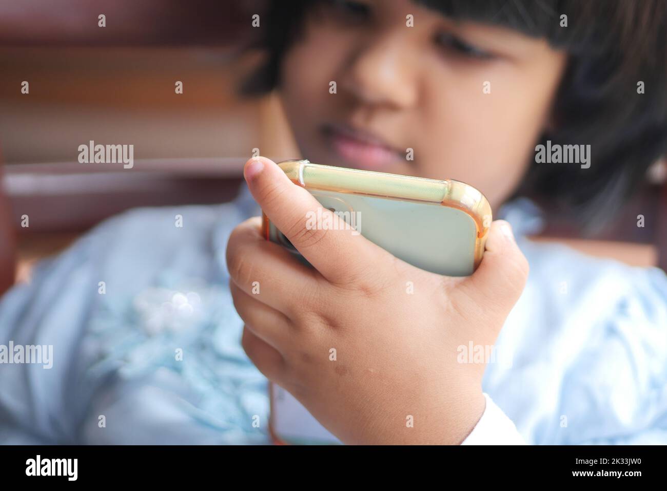 Child girl watching cartoon on smart phone Stock Photo - Alamy