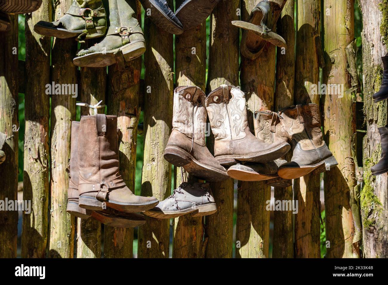 Cowboy boots on fence hi-res stock photography and images - Alamy