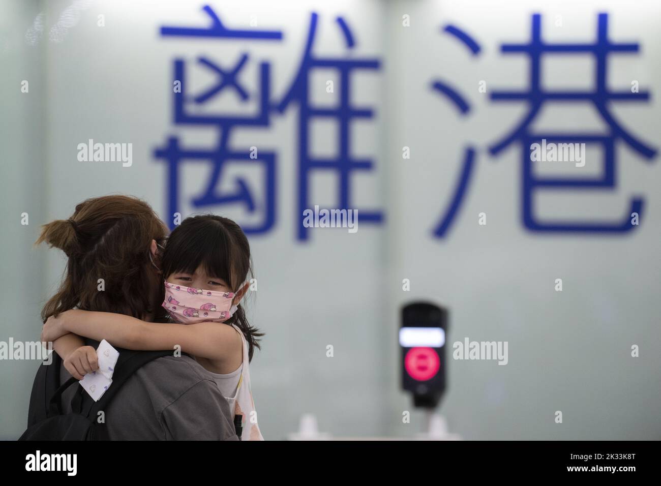 Friends and family wave goodbye to travelers at departures area on Hong ...