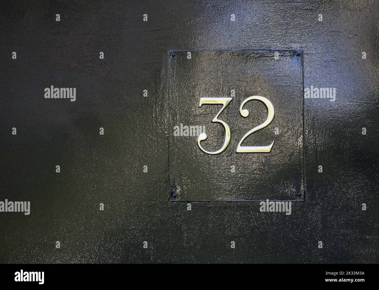 Antique brass street number on a handcrafted metal entrance gate Stock ...