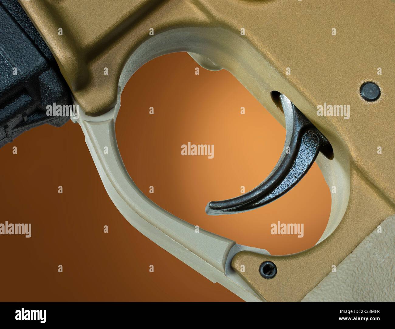 Assault rifle trigger that has a brown background behind Stock Photo ...
