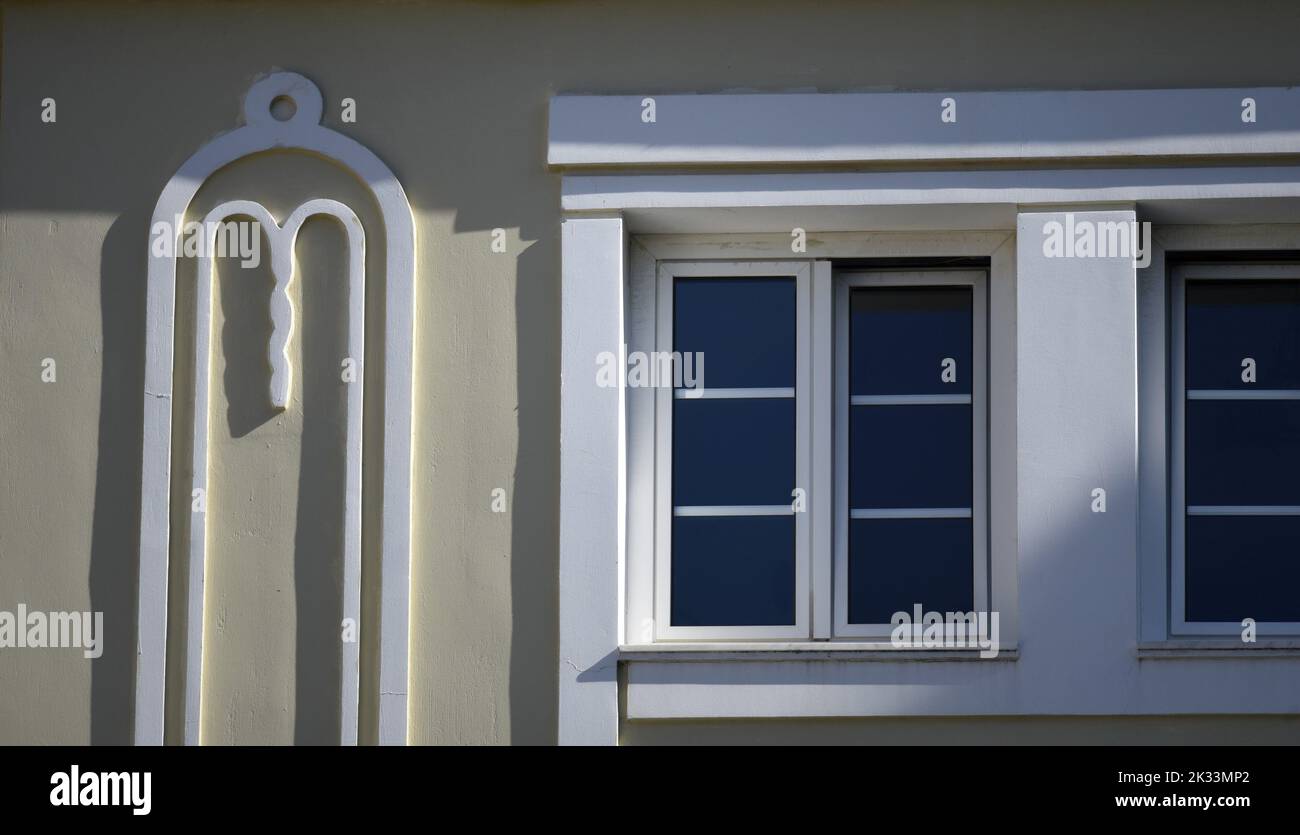 Neoclassical house windows with white trim on a stucco wall Stock Photo ...