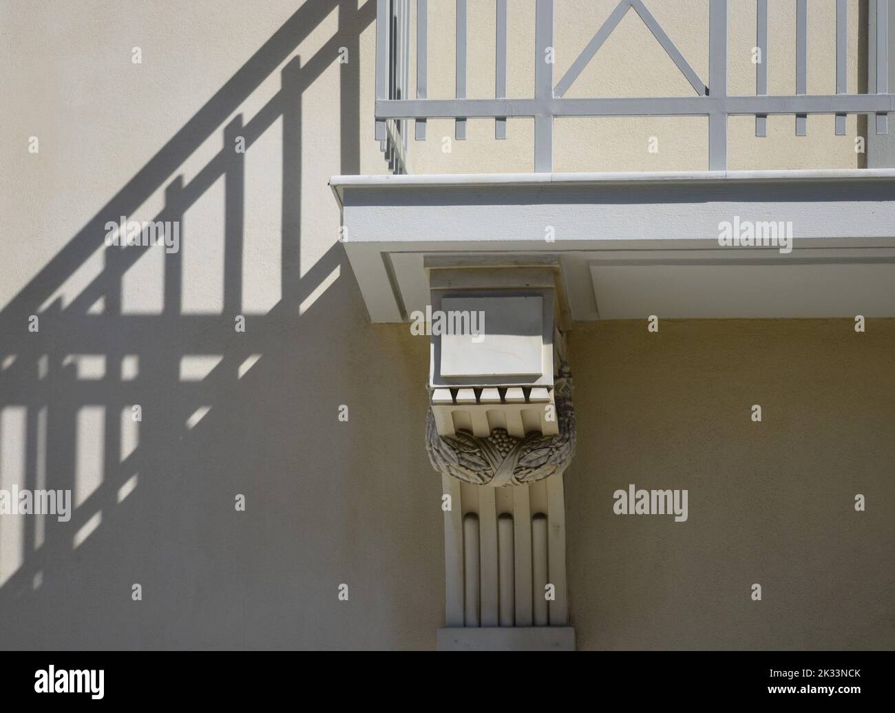Neoclassical mansion balcony with a grey metal railing and a ...