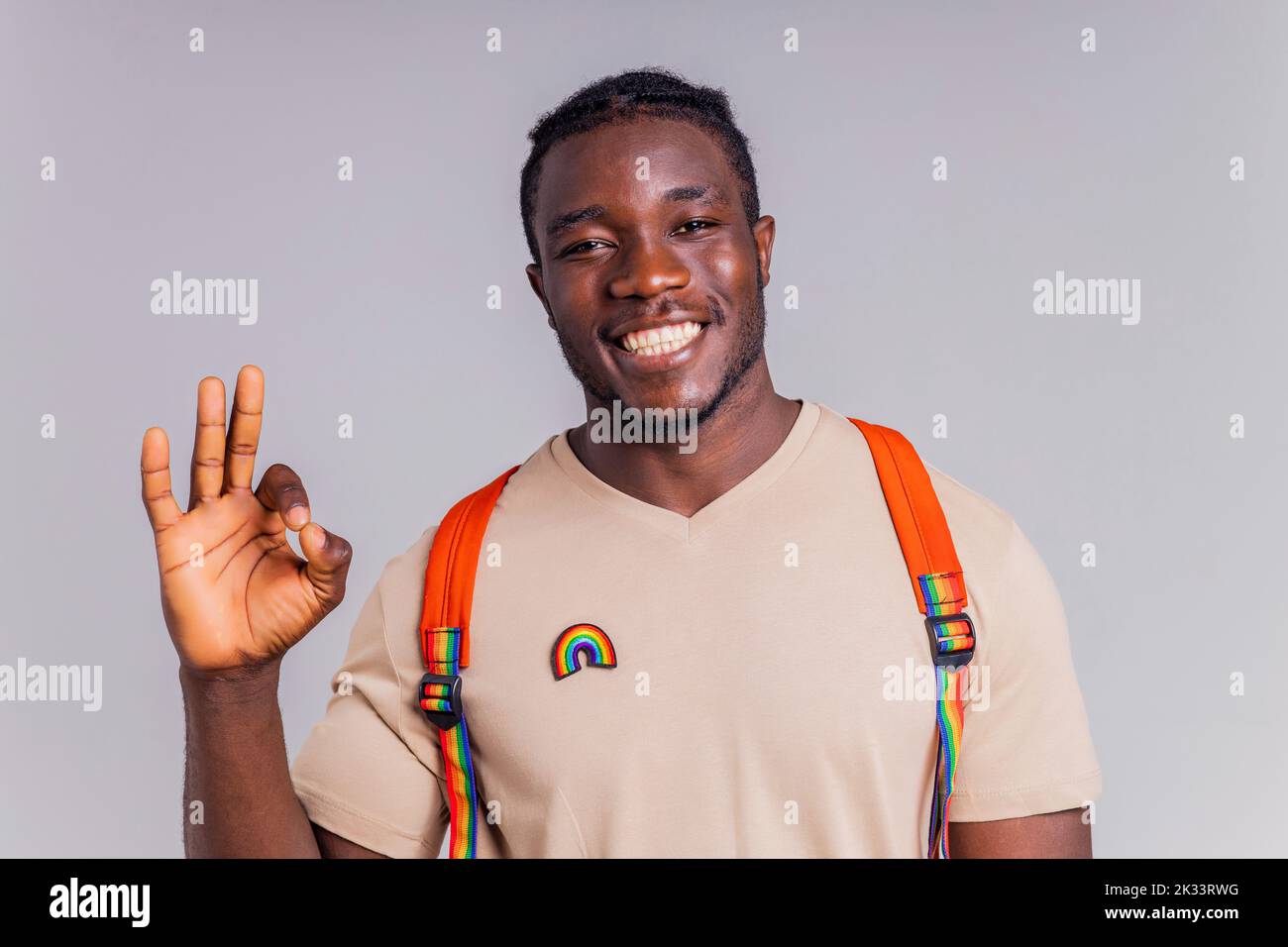 african american man student with backpack in studio smiling at the ...