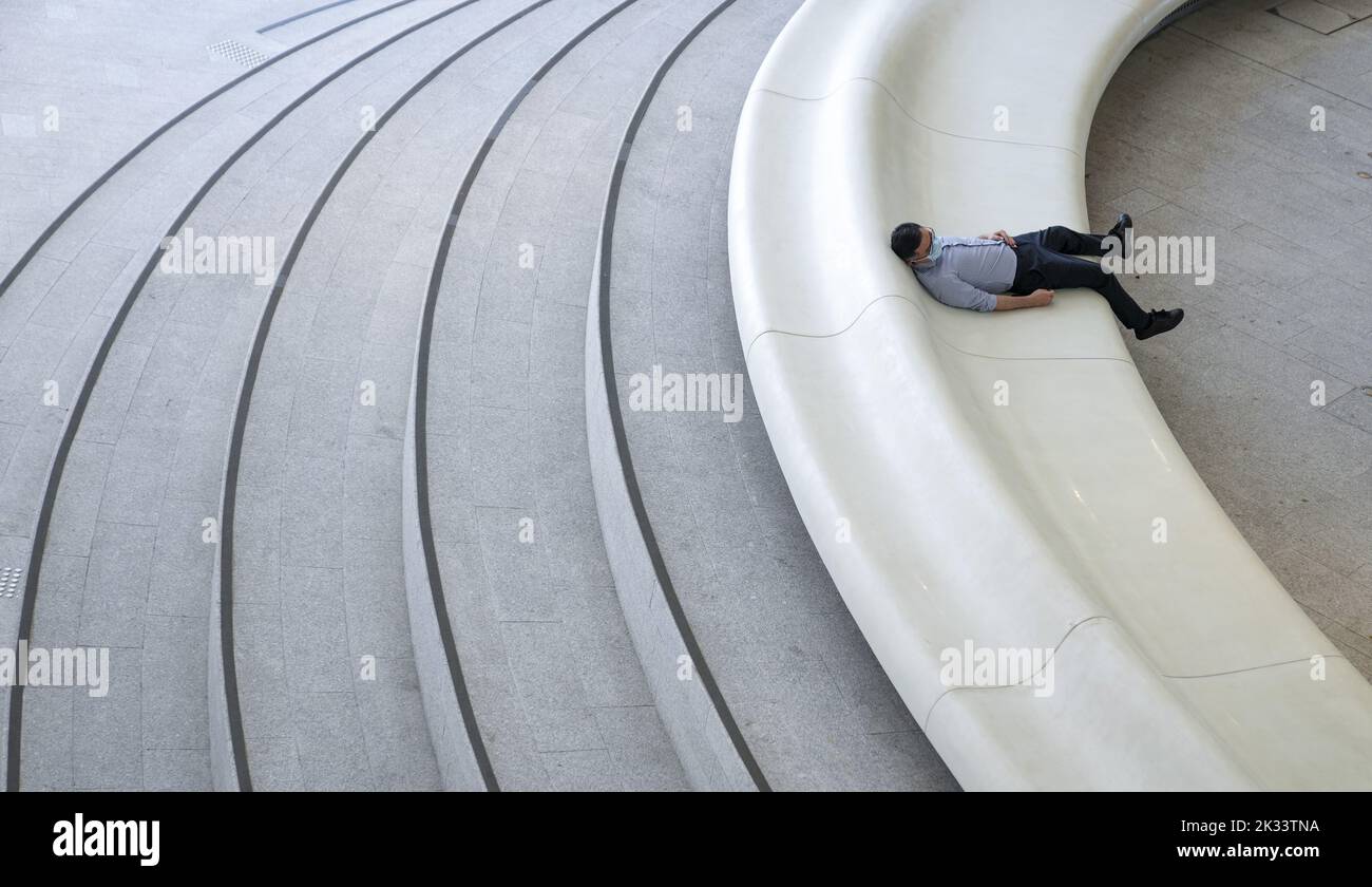 A man sleeping in the open area of Xiqu Centre at West Kowloon Cultural ...